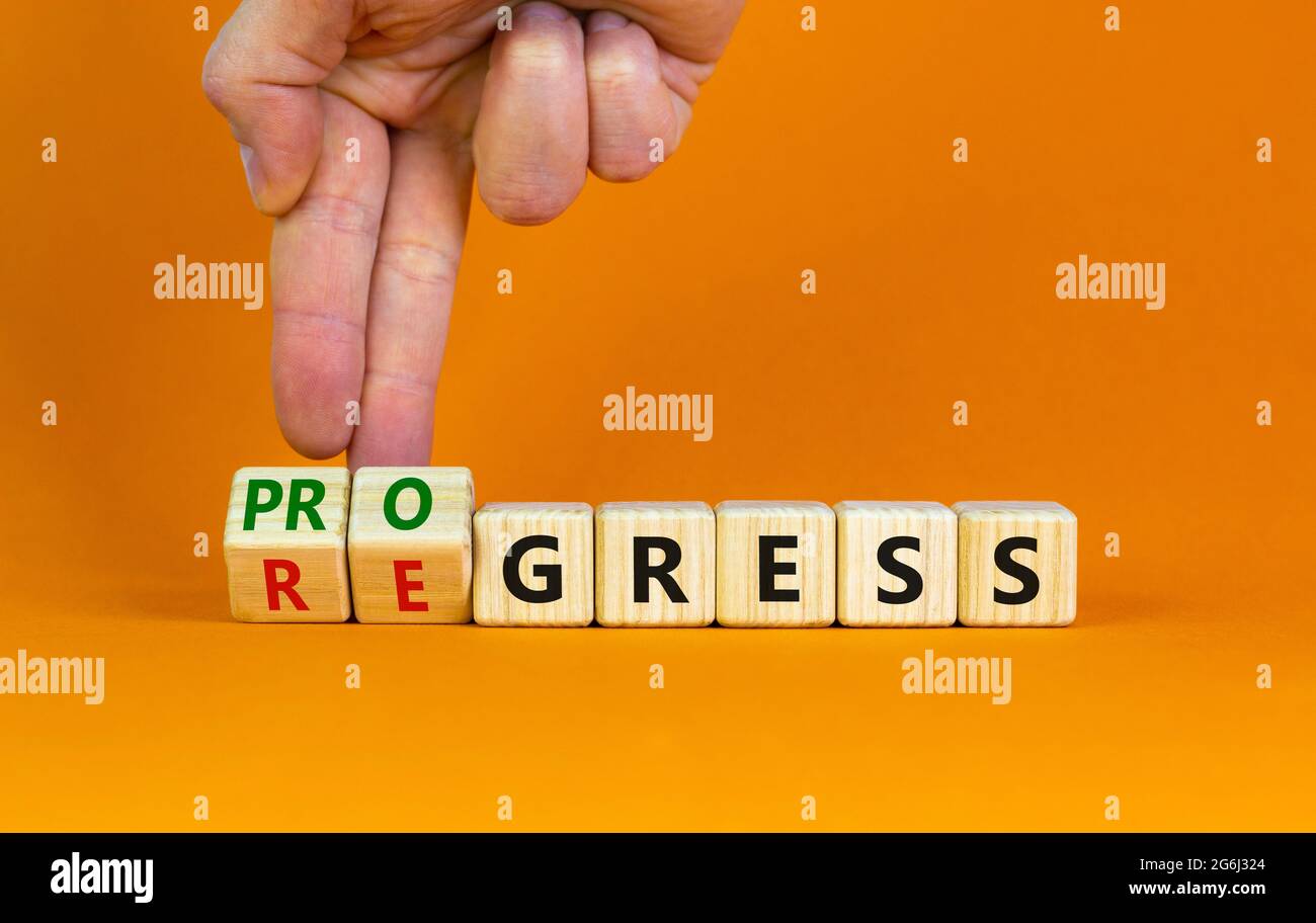 Regress or progress symbol. Businessman turns wooden cubes and changes ...