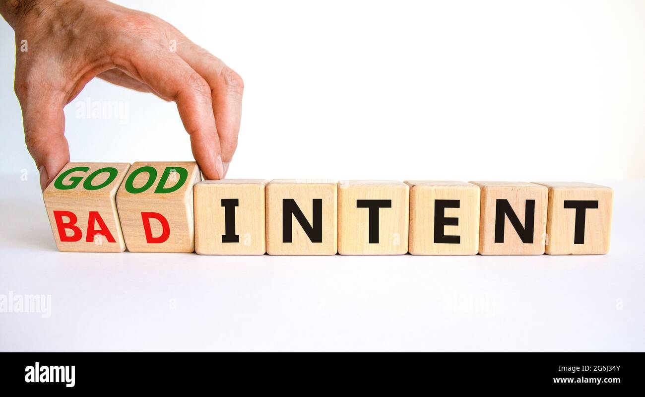 Good or bad intent symbol. Businessman turns wooden cubes and changes ...