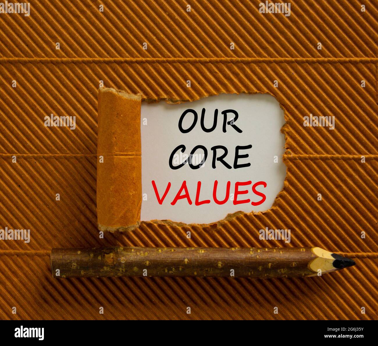 Our core values symbol. Words 'Our core values' appearing behind torn ...