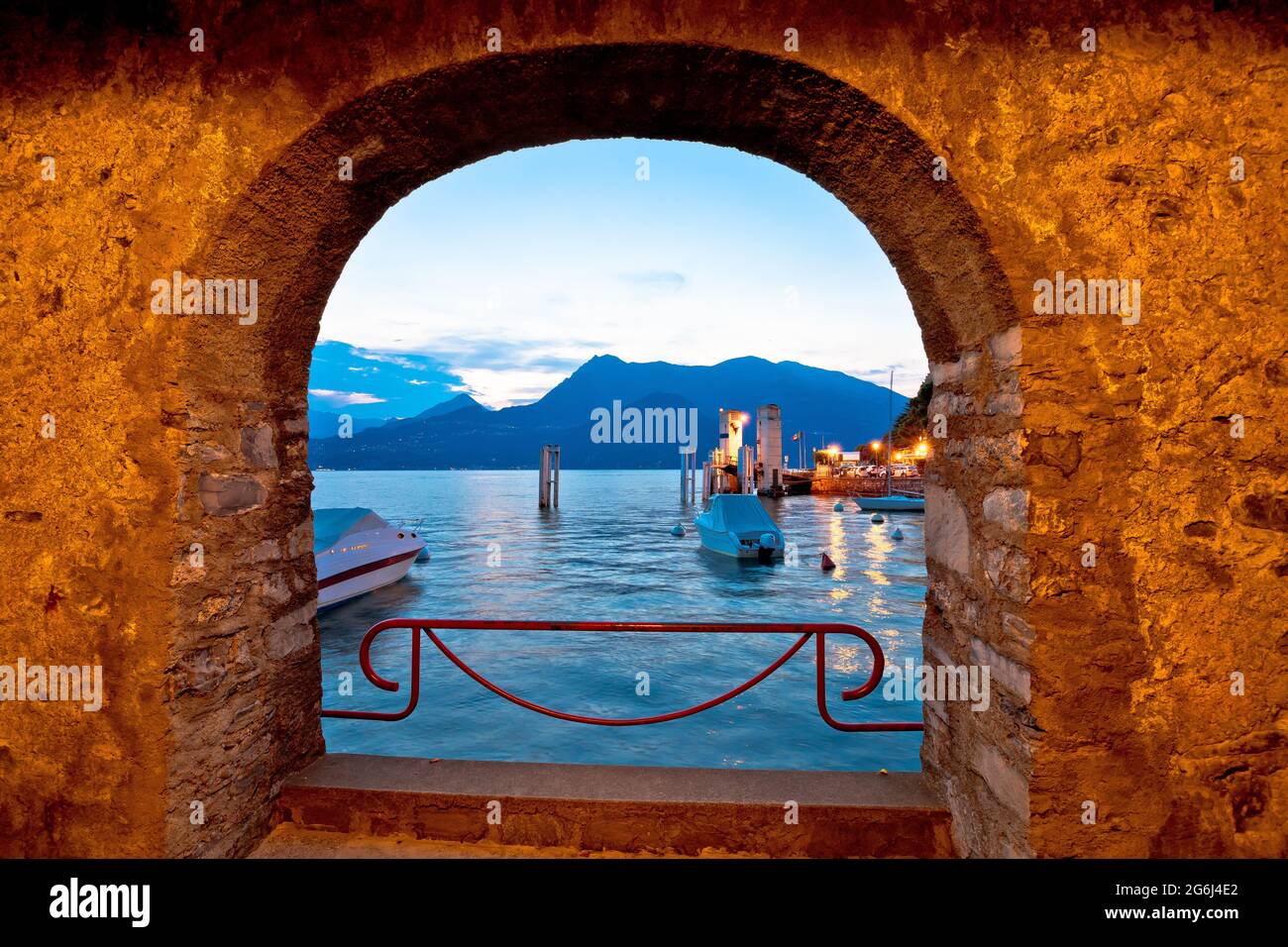 Town of Varenna lakefront evening view through stone window evening ...