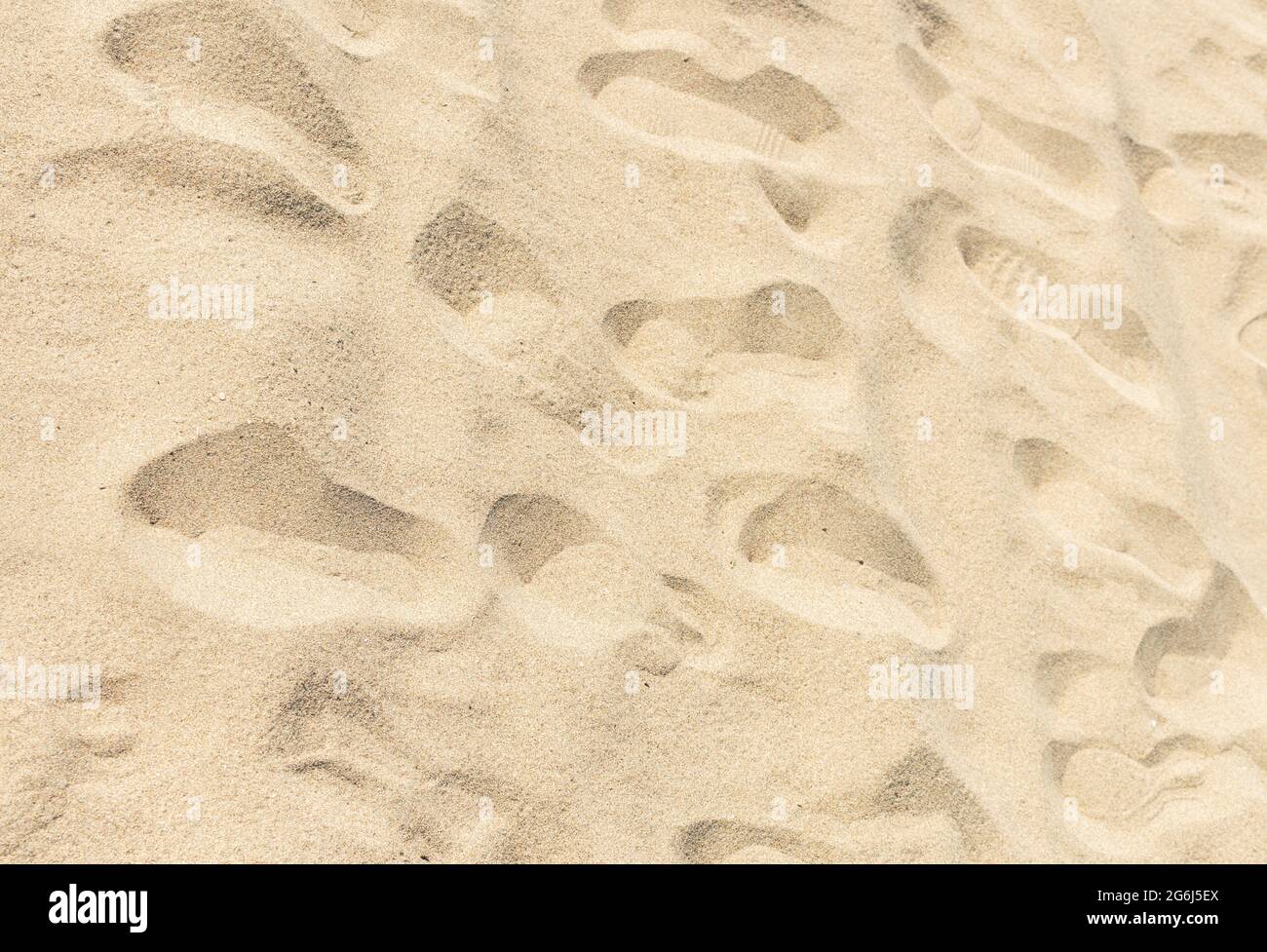 multiple footprints on the beach. vacation concept. people flocking to ...