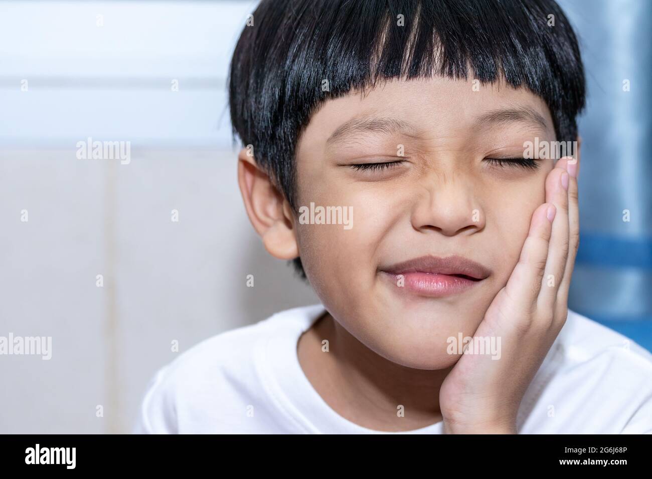 Asian little boy is doing a terrible toothache. Portrait a little boy ...