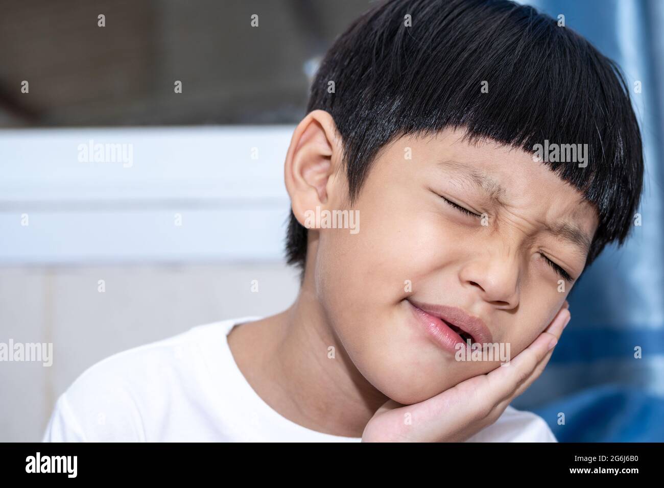Asian little boy is doing a terrible toothache. Portrait a little boy ...