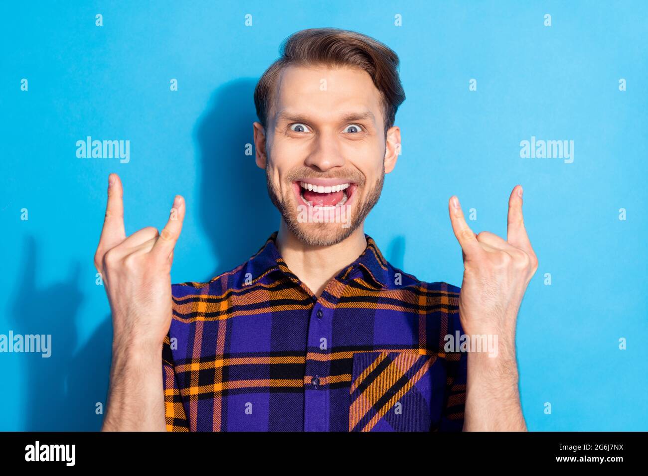 Photo of cheerful happy crazy young man make horned signs good mood ...