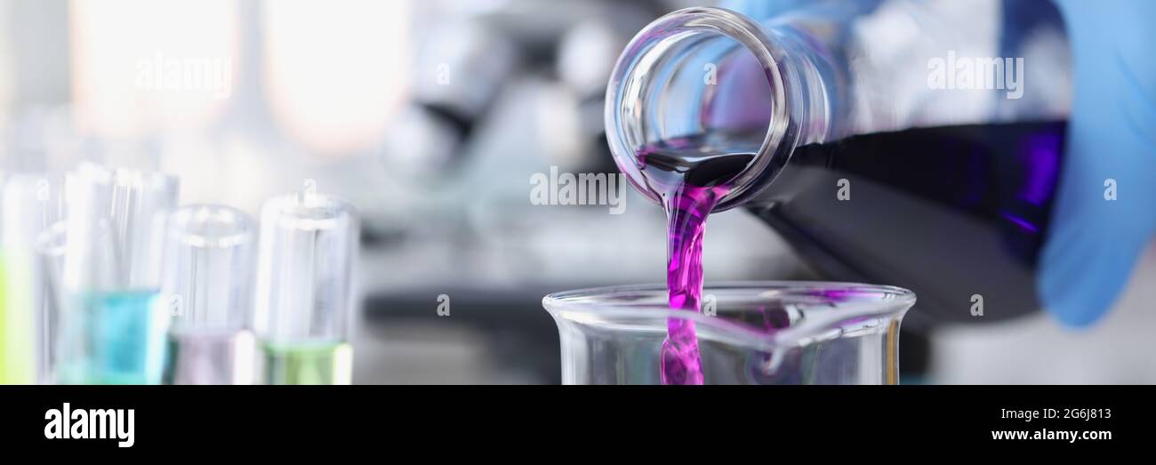Scientist chemist pouring pink liquid hi-res stock photography and ...