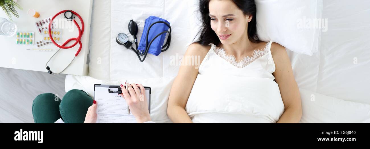 Doctor examining patient in bed at home top view Stock Photo - Alamy