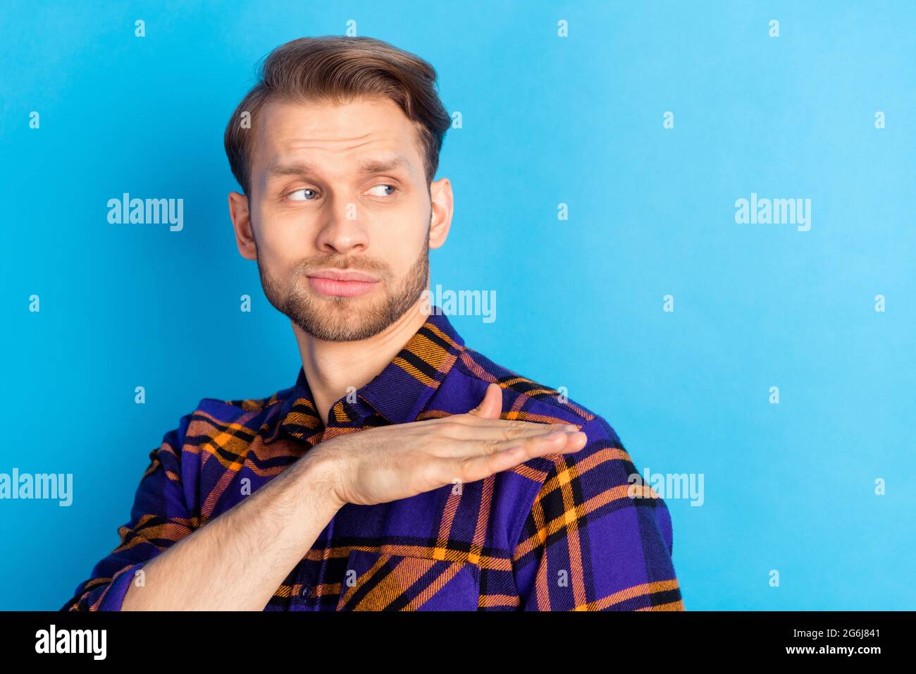 Photo of young man arm palm look interested empty space wear plaid ...