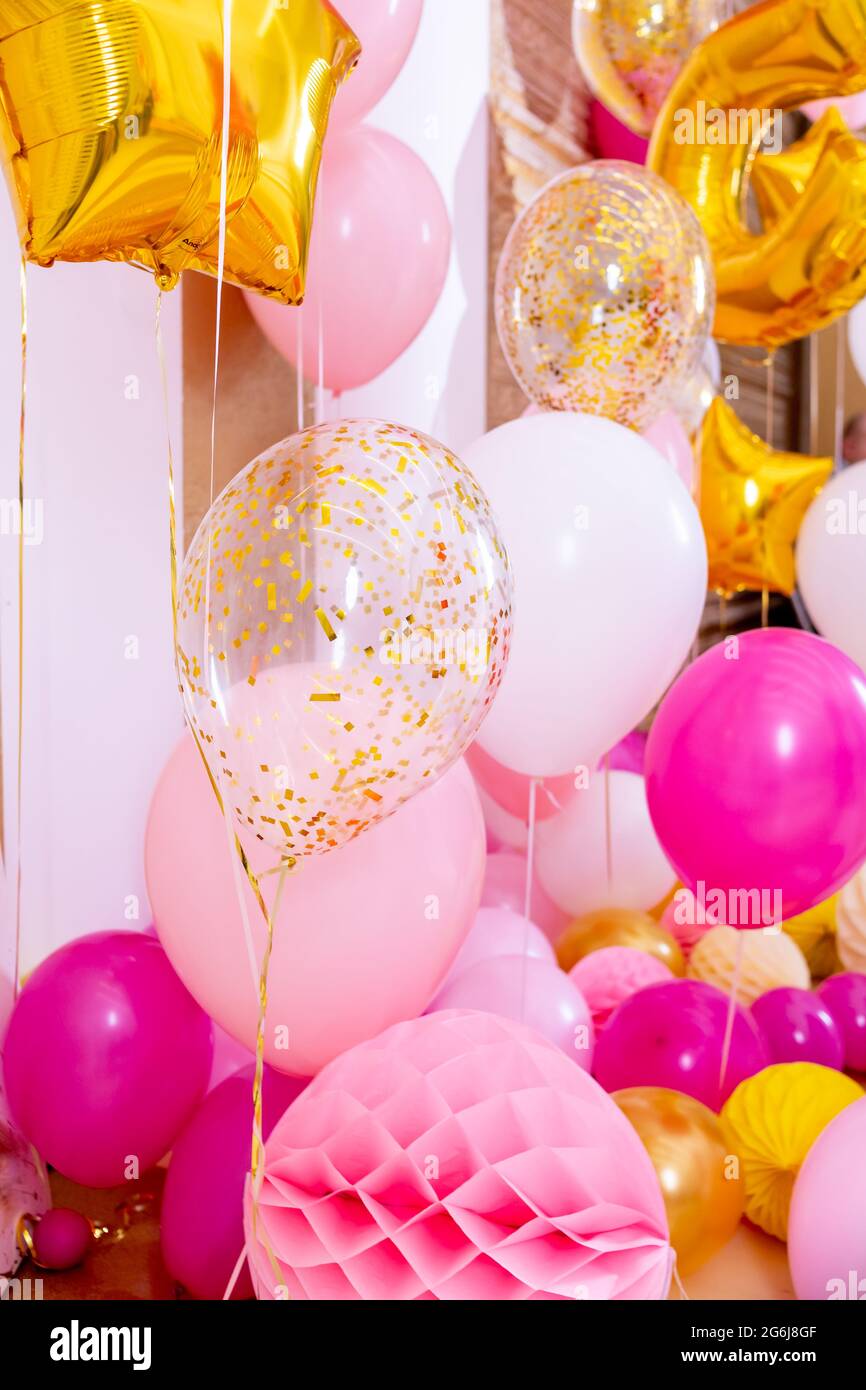 Pink and white baloons at reception hall.Balloons filled with helium ...