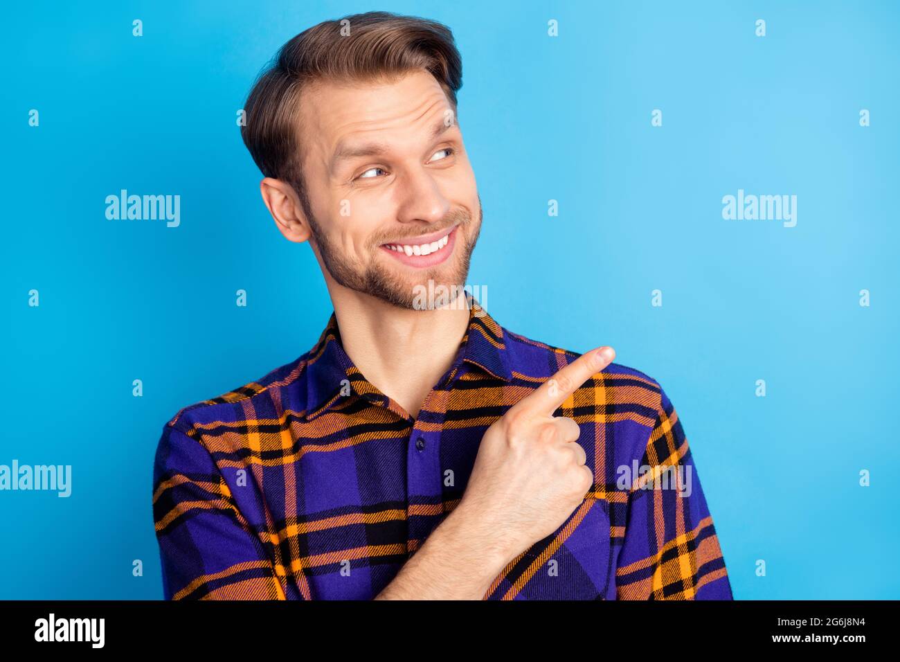 Photo of charming happy young old man look point finger empty space ...