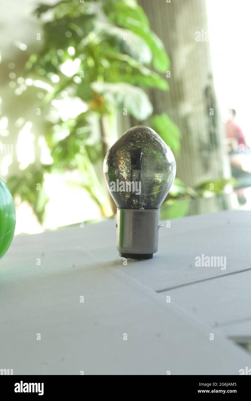 upright old dirty single transparent bulb closeup creative idea blurry ...