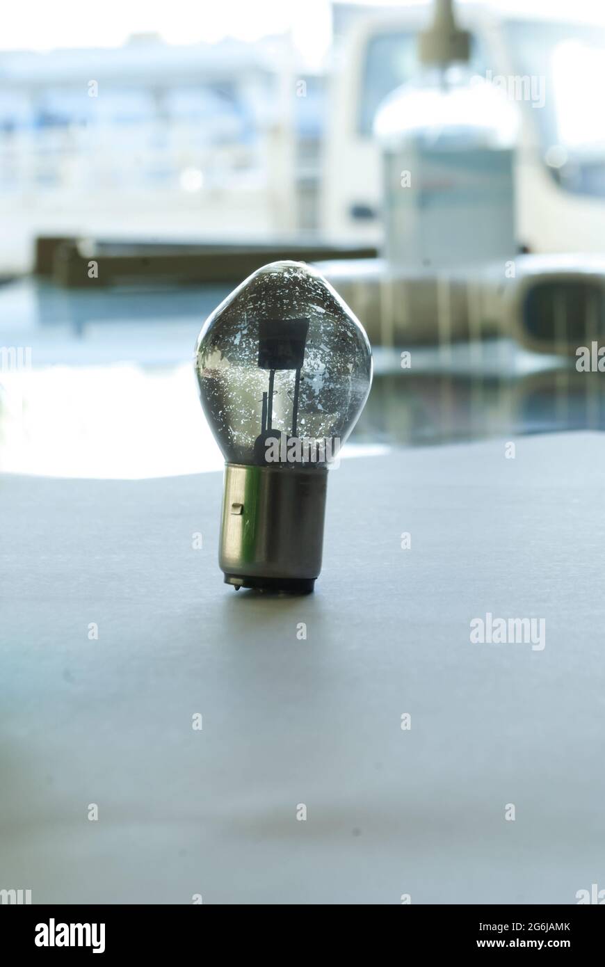 upright old dirty single transparent bulb closeup creative idea blurry ...