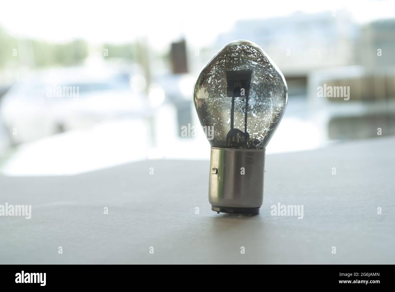 upright old dirty single transparent bulb closeup creative idea blurry ...