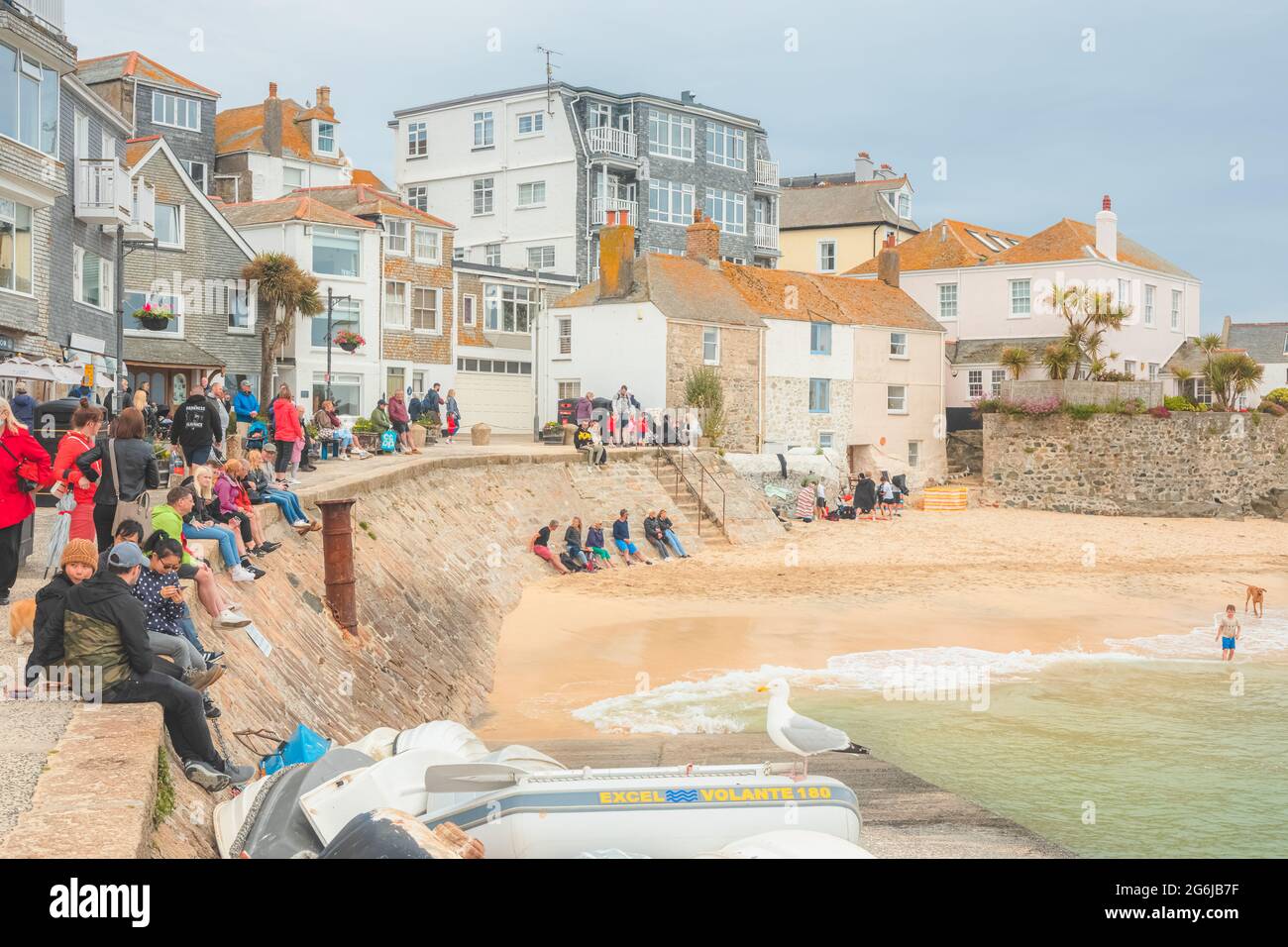 St Ives, UK - June 21 2021: Tourists enjoying the harbour of scenic ...