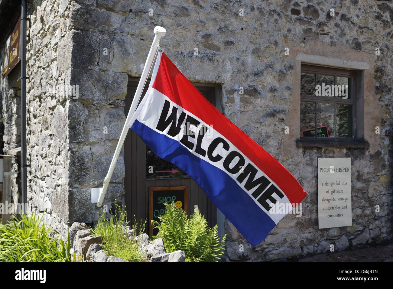 Red, White and Blue WELCOME flag blowing in the wind. Photographed from ...