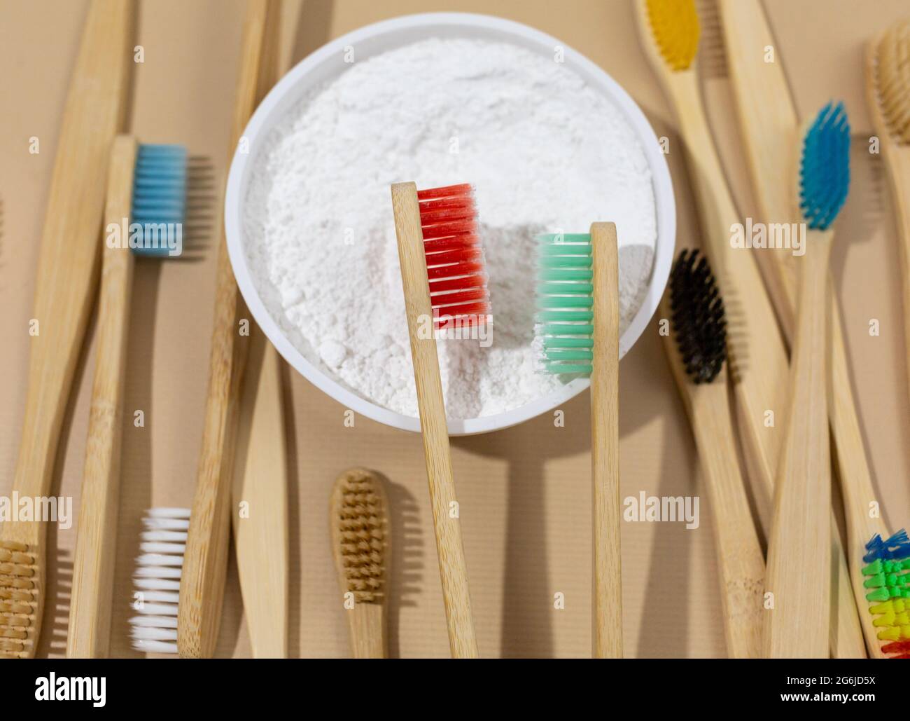 A set of multicolored eco-friendly bamboo toothbrushes and white tooth ...