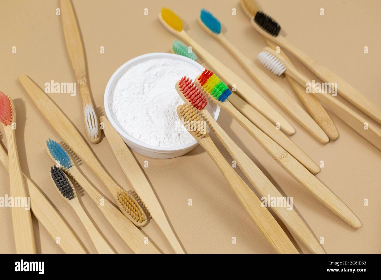 A set of multicolored eco-friendly bamboo toothbrushes and white tooth ...