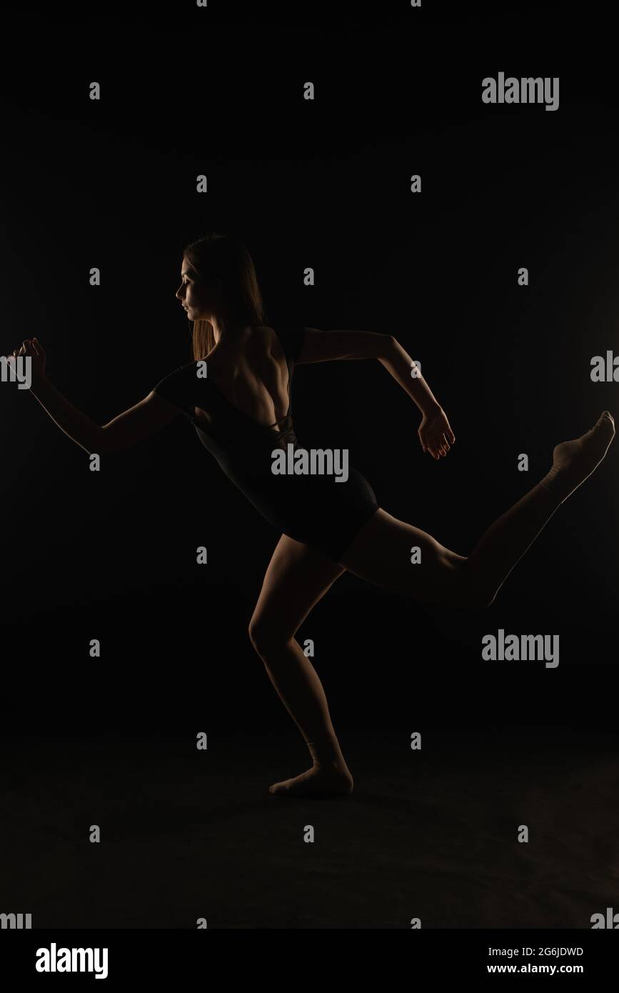 Young ballerina is posing how she is running in studio Stock Photo - Alamy