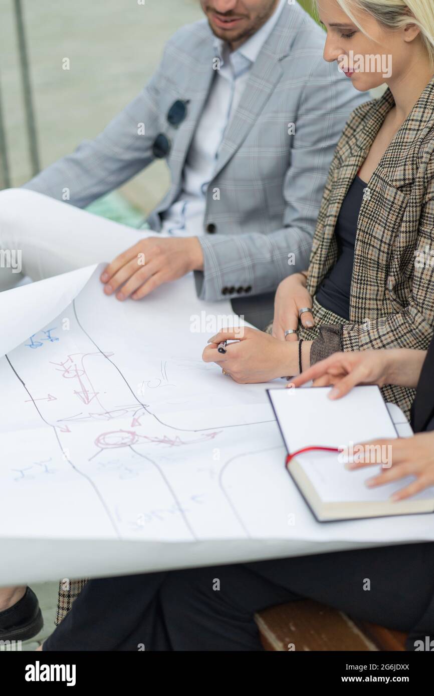 Two urbna business people are making the blueprints for the hall of ...