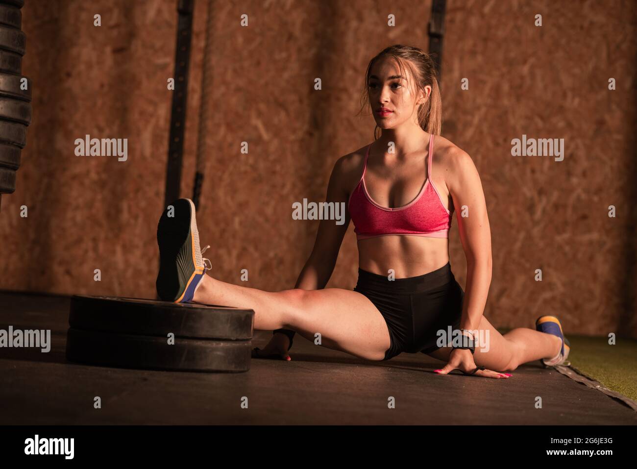 Beautiful and attractive fit girl is doing some splits in the gym Stock Photo - Alamy