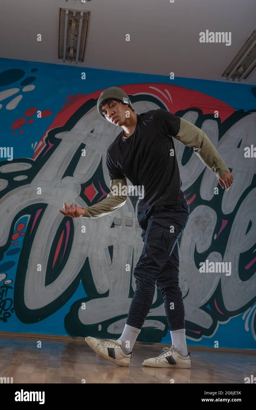 Modern rapper dancing in garage. Urban lifestyle, hip hop Stock Photo ...