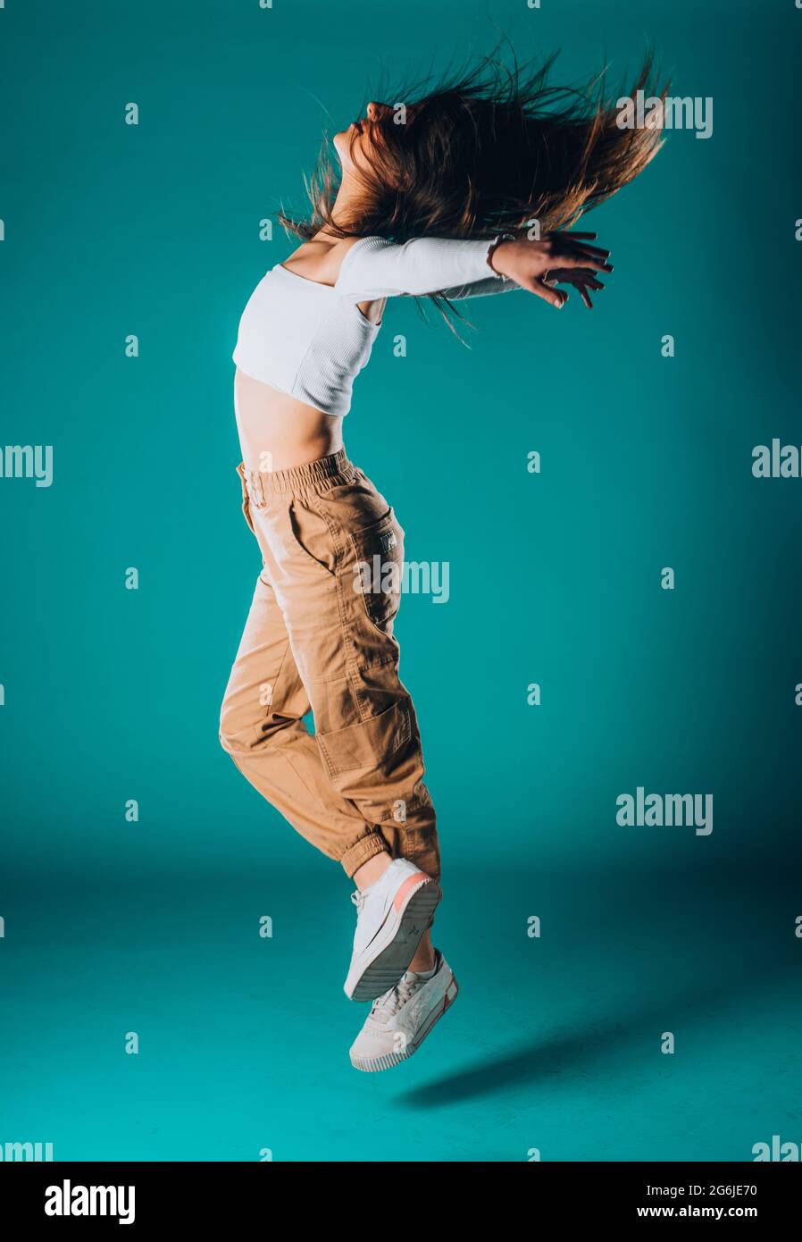 Flexible young dancer performing a stylish dance movement Stock Photo ...