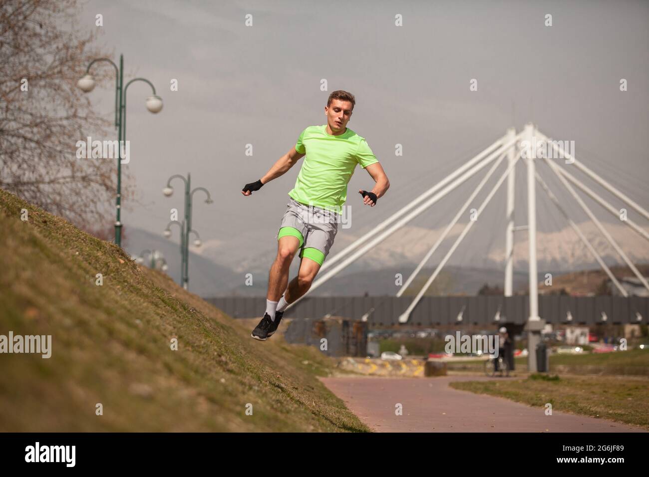 Male sportsman is running on the side wall while jumping of it Stock ...