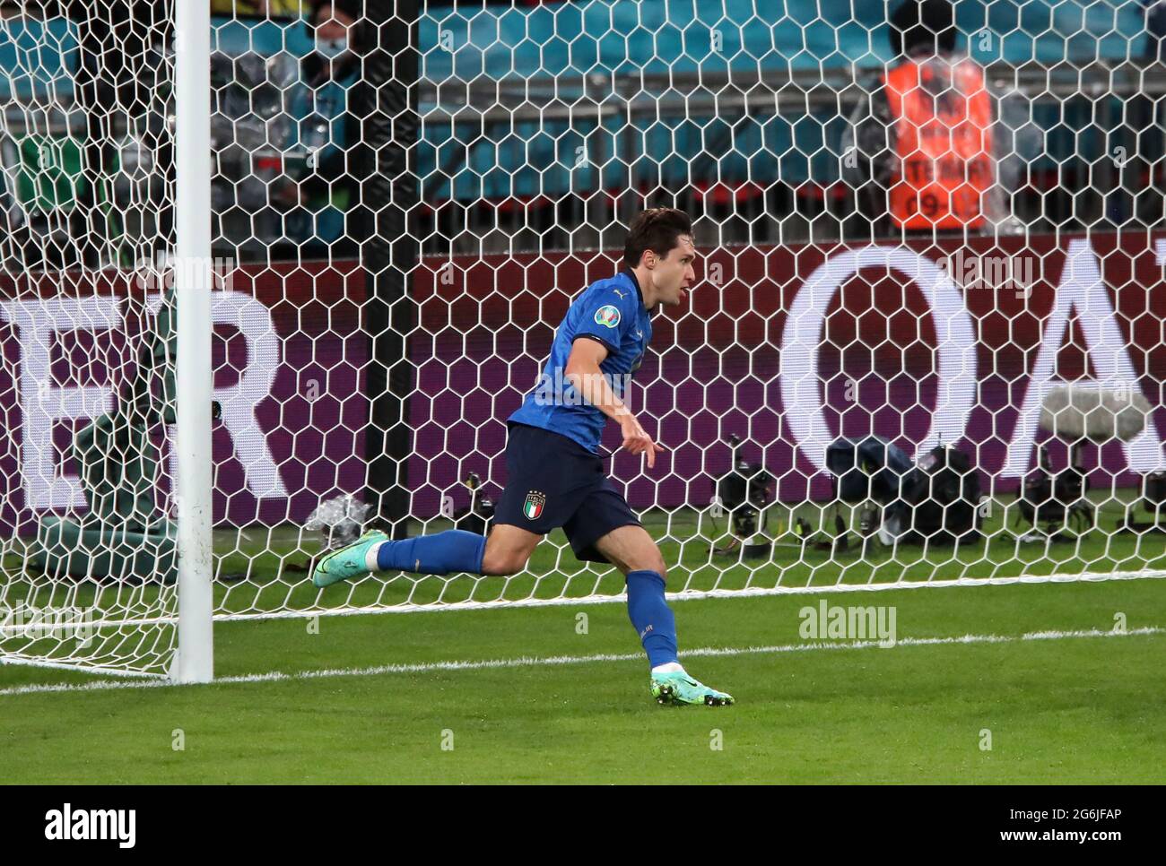 Italy's Federico Chiesa (left) celebrates scoring their side's first ...