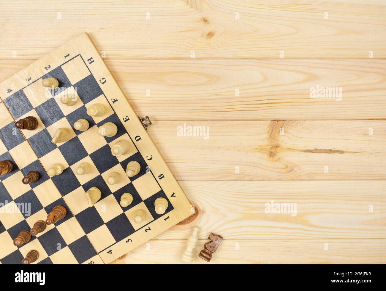 Chess board and chess figures on wooden background. Popular logic game ...