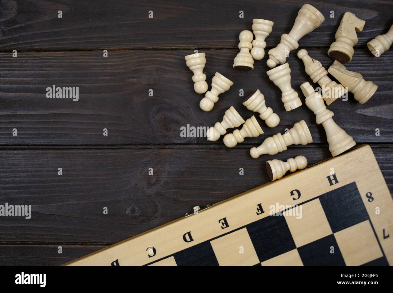 Chess board and chess figures on dark wooden table. Popular logic game ...