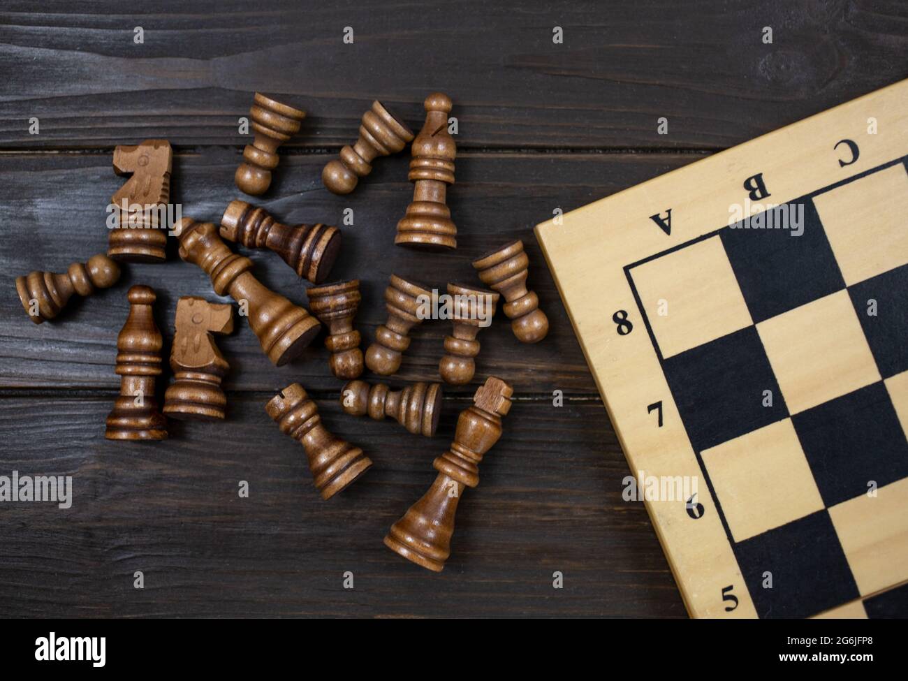 Chess board and chess figures on dark wooden table. Popular logic game ...