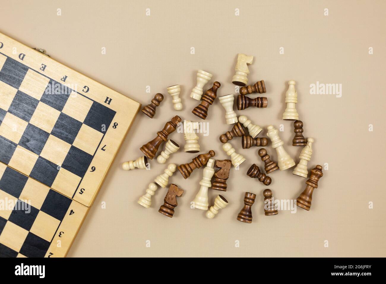 Chessboard and chess figures, wooden cubes, puzzle games on beige ...