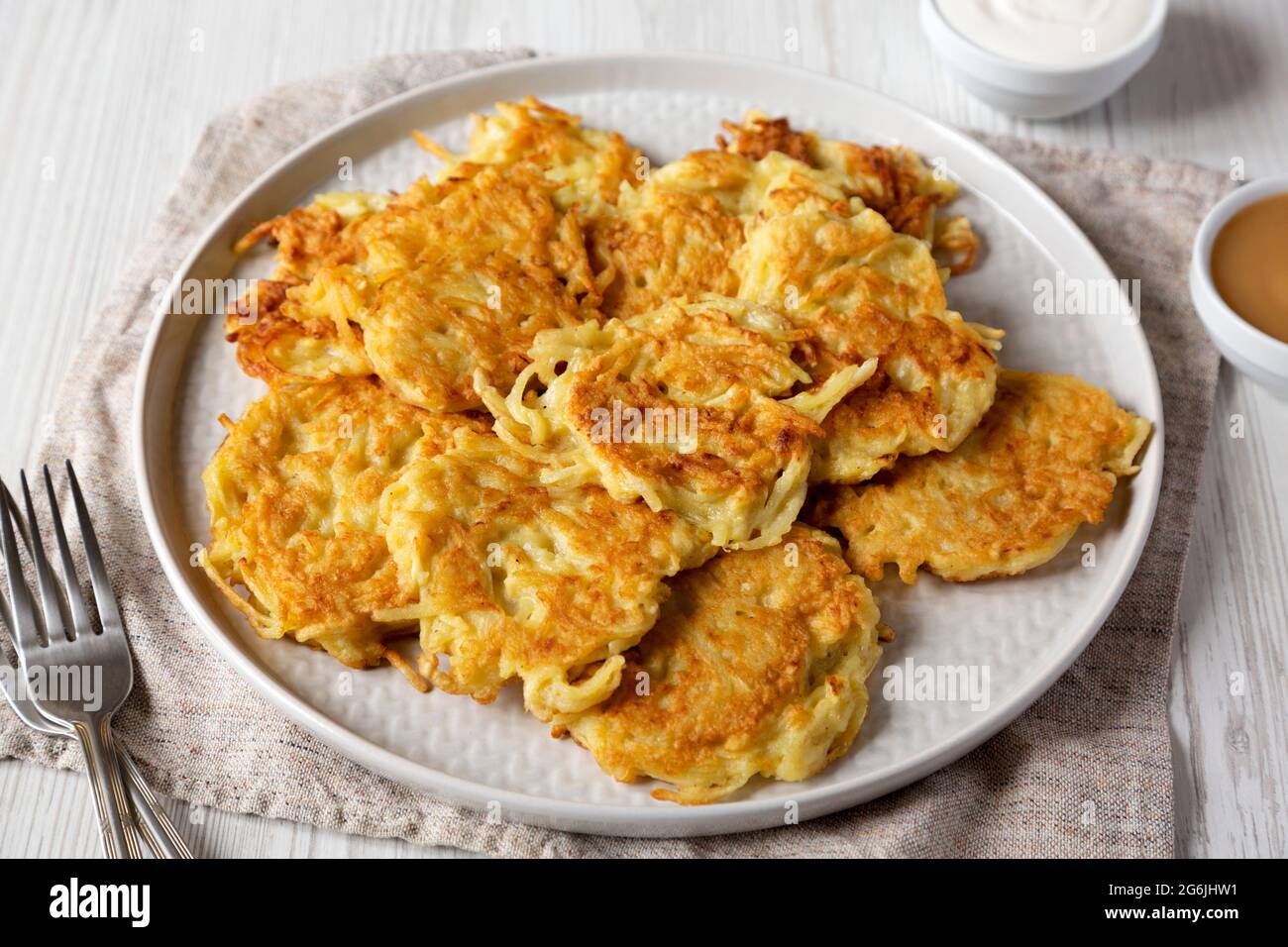 Homemade Potato Pancakes Latkes with Apple Sauce and Sour Cream on a ...