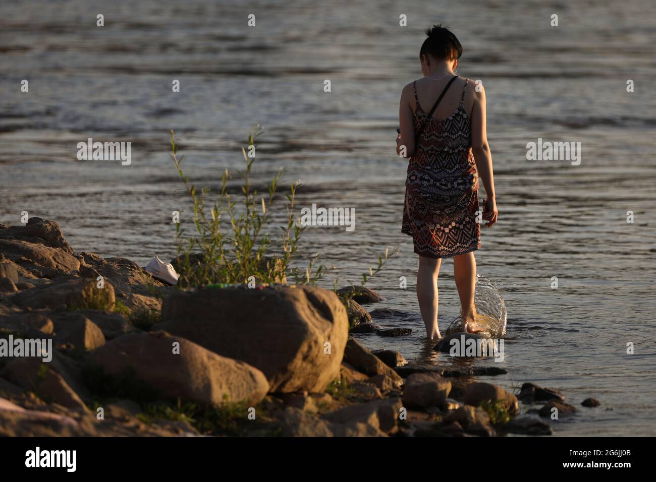 People are seen enjoying the warm weather at at a beach on the Vistula ...
