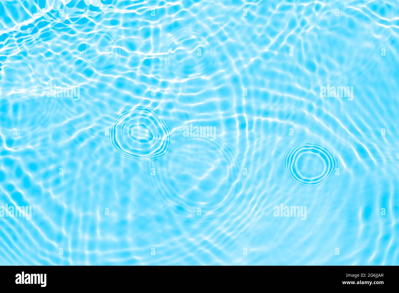 Surface of blue transparent swimming pool water with the circles on the ...