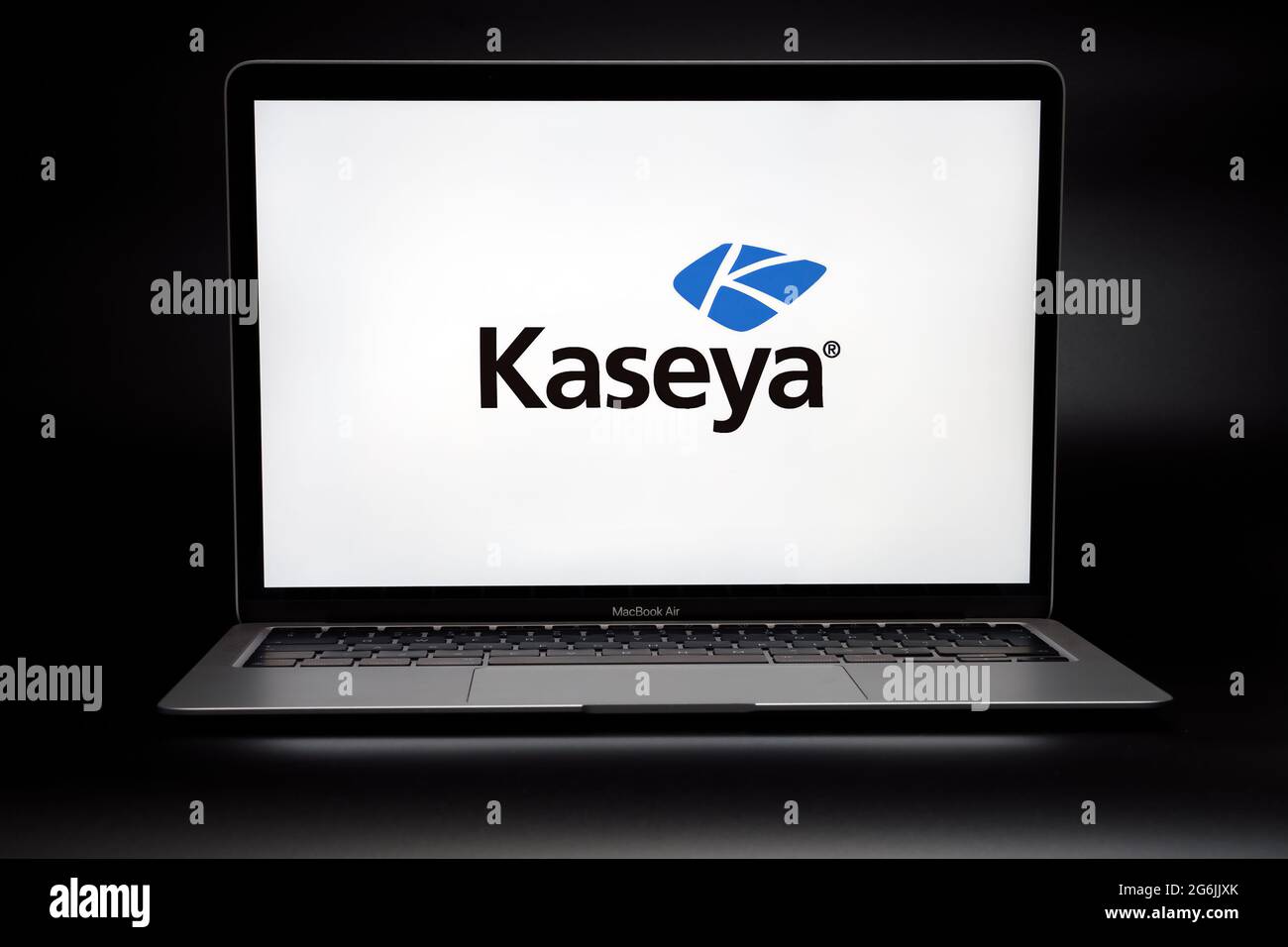 Kaseya company logo on the screen of laptop in dark room. Concept for ...