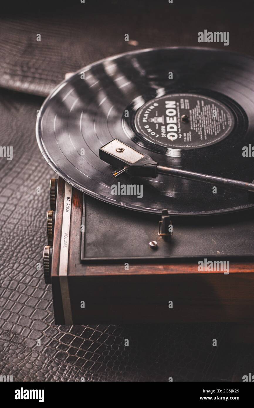 Record player with vinyl disc on table in room Stock Photo - Alamy