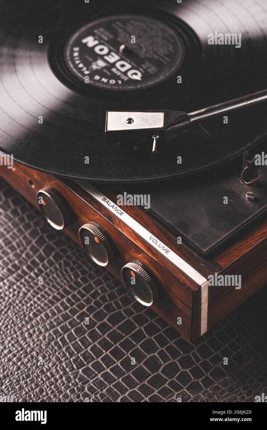 Record player with vinyl disc on table in room Stock Photo - Alamy