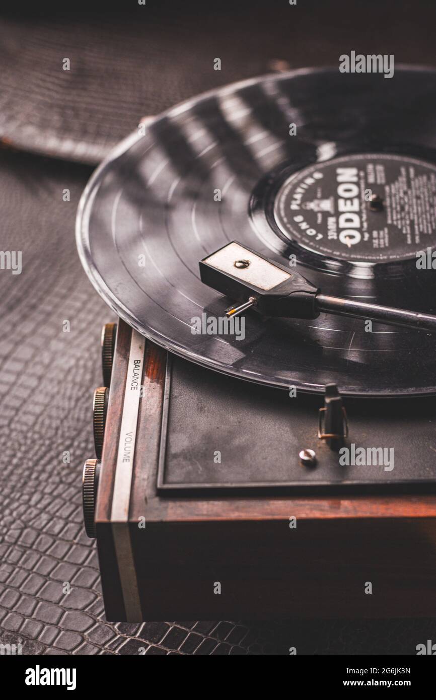 Record player with vinyl disc on table in room Stock Photo - Alamy