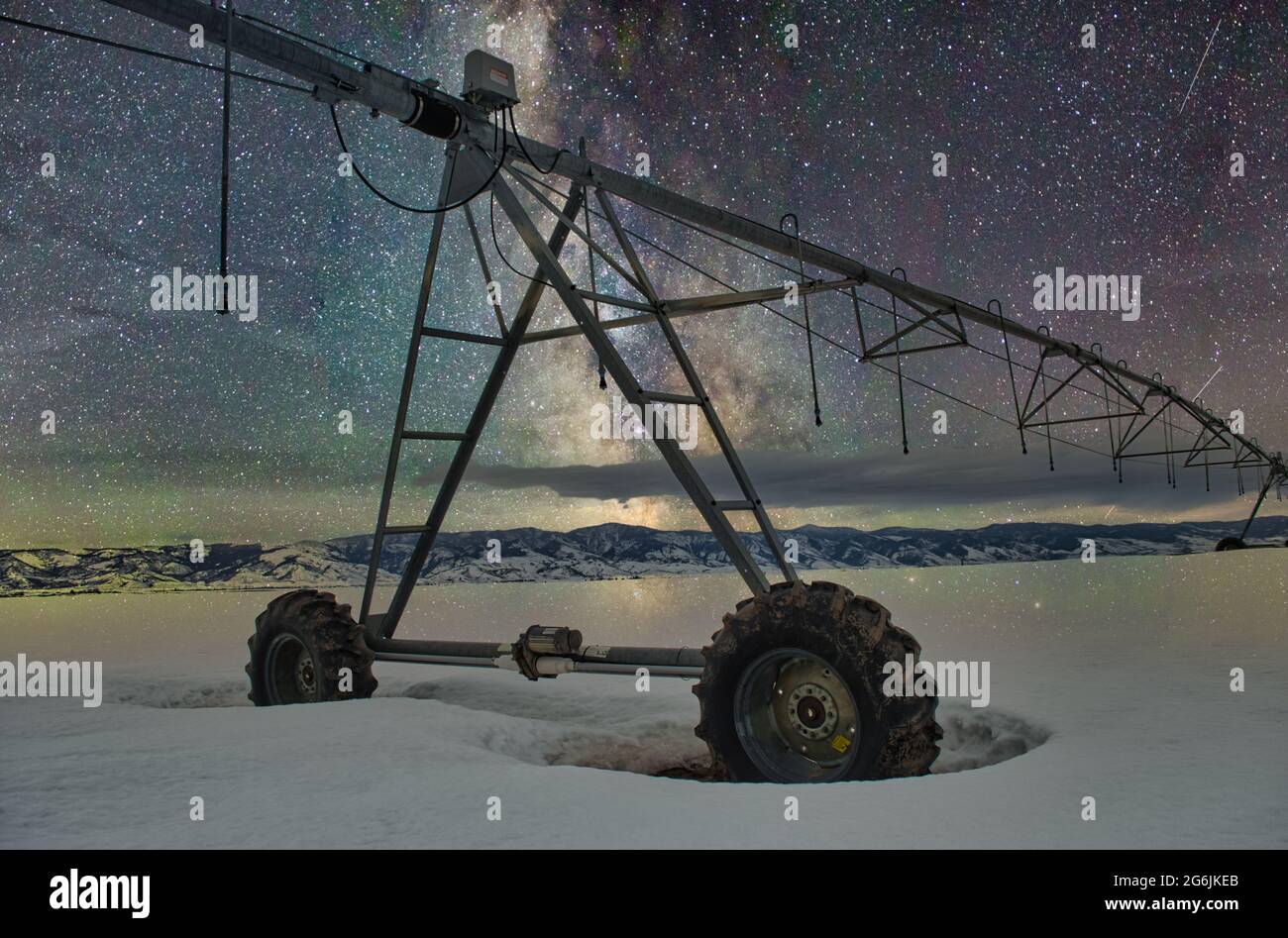 Closeup shot of a farm sprinkling machine on a shiny sky background ...