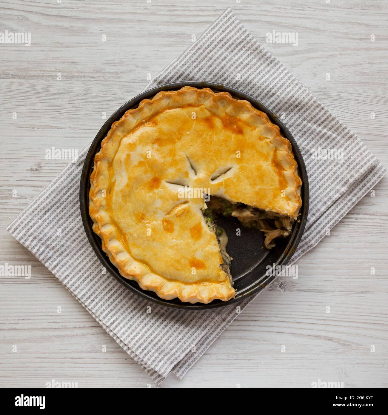 A Piece of Chicken Pot Pie on a white wooden background, top view. Flat ...