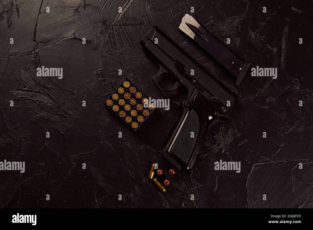 Flat lay of cartridges and gun on concrete background. Pistol and ...