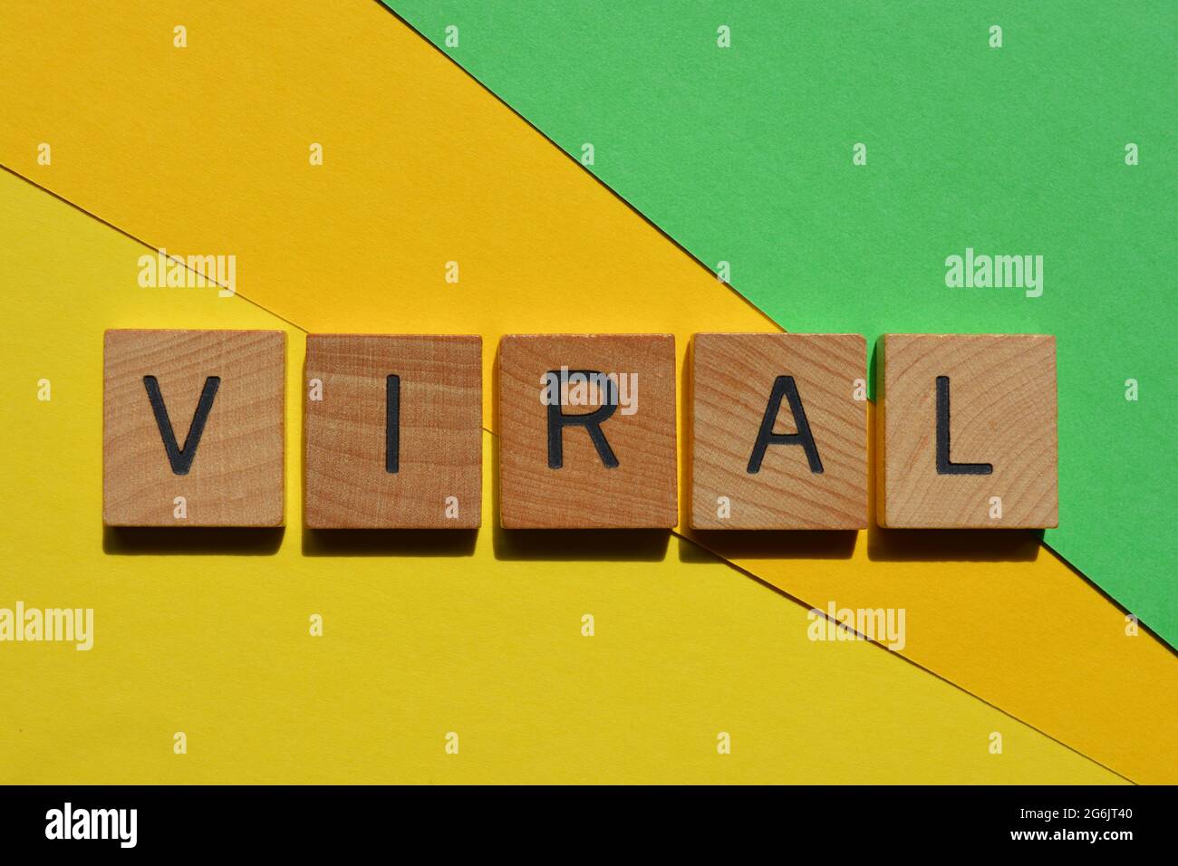 Viral, word in wooden alphabet letters isolated on yellow and green ...