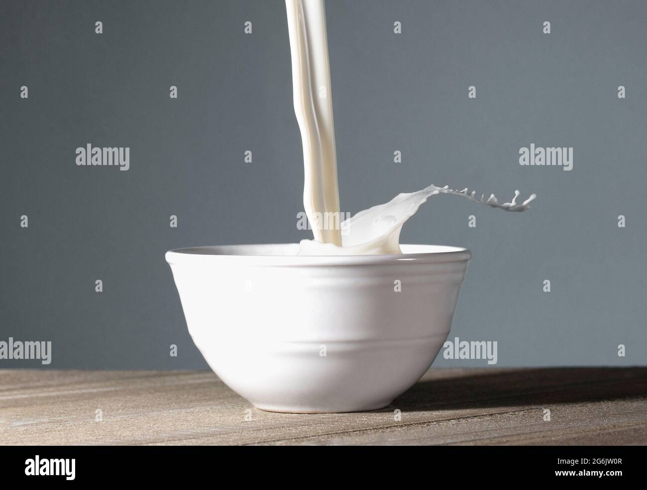 A Bowl of MIlk Being Poured and Splashing Out Stock Photo - Alamy