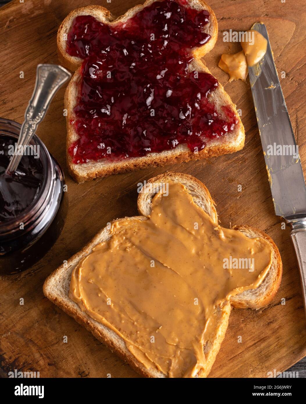 Fixing a Peanut Butter and Jelly Sandwich on a Wooden Kitchen Counter ...