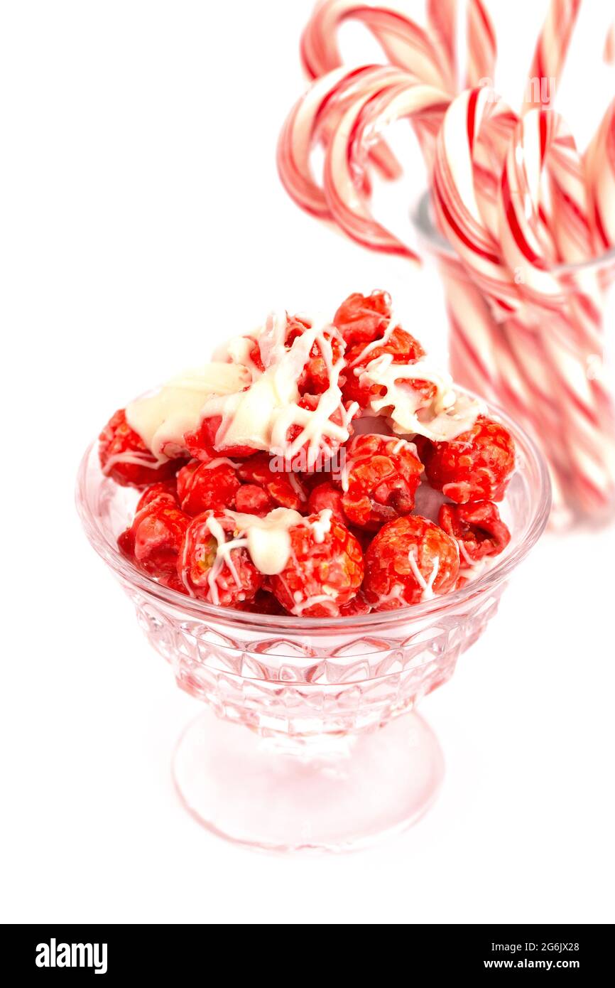 Candy Cane White Chocolate Drizzled Red Popcorn on a White Background ...