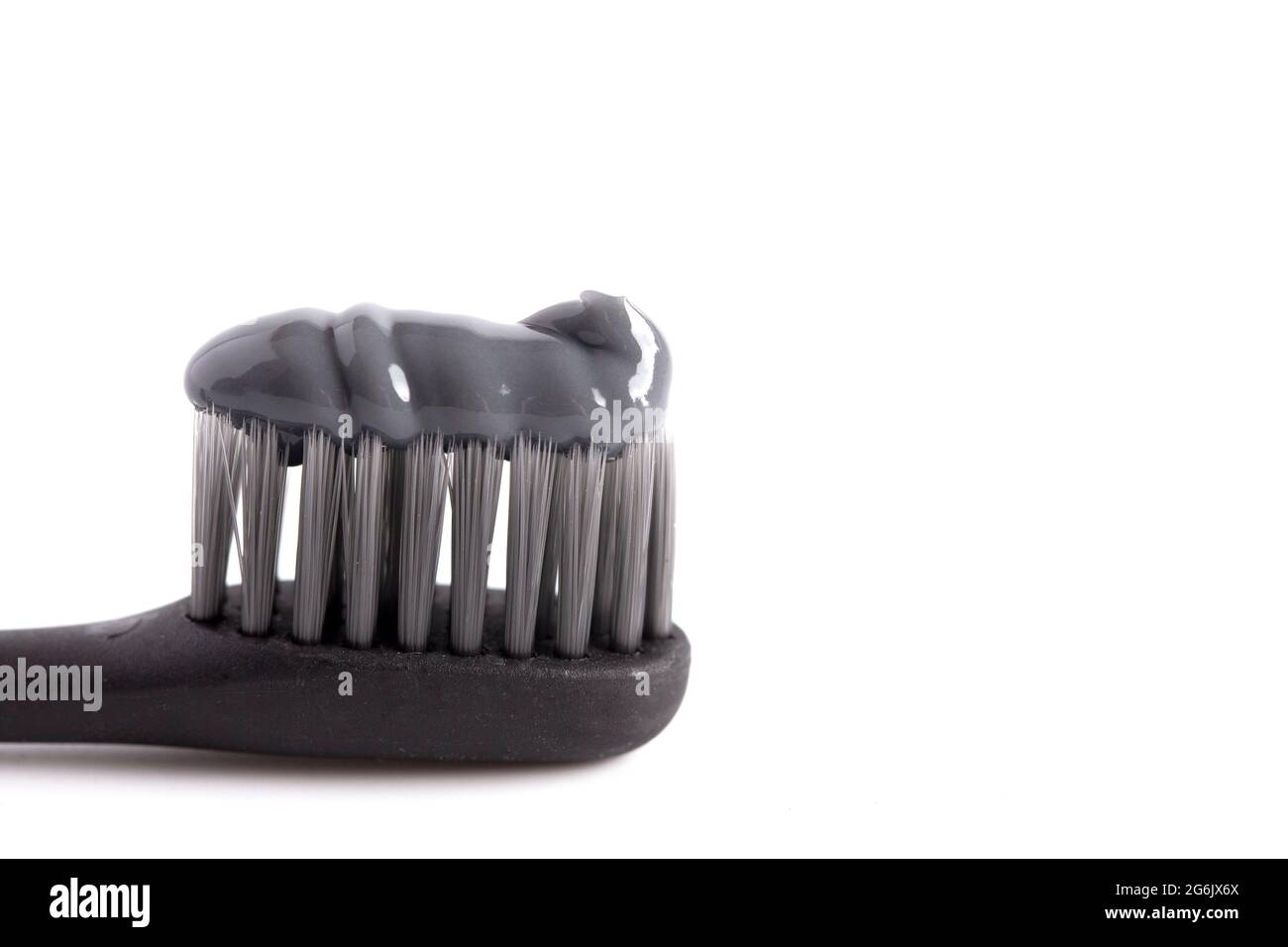 Black Toothbrush with Black Activated Charcoal Toothpaste on a White ...