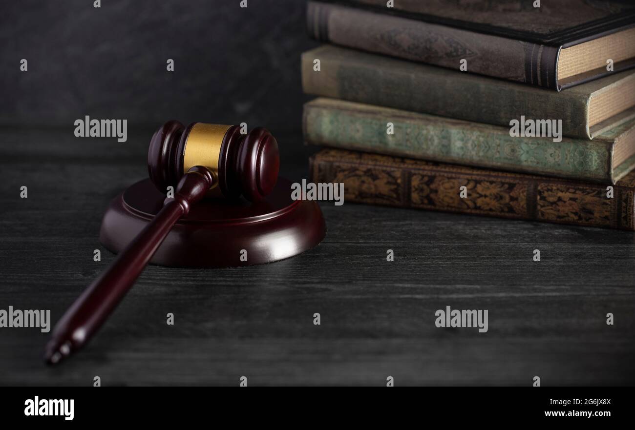 Wooden Judges Gavel on a Desk with Books in the Background Stock Photo ...