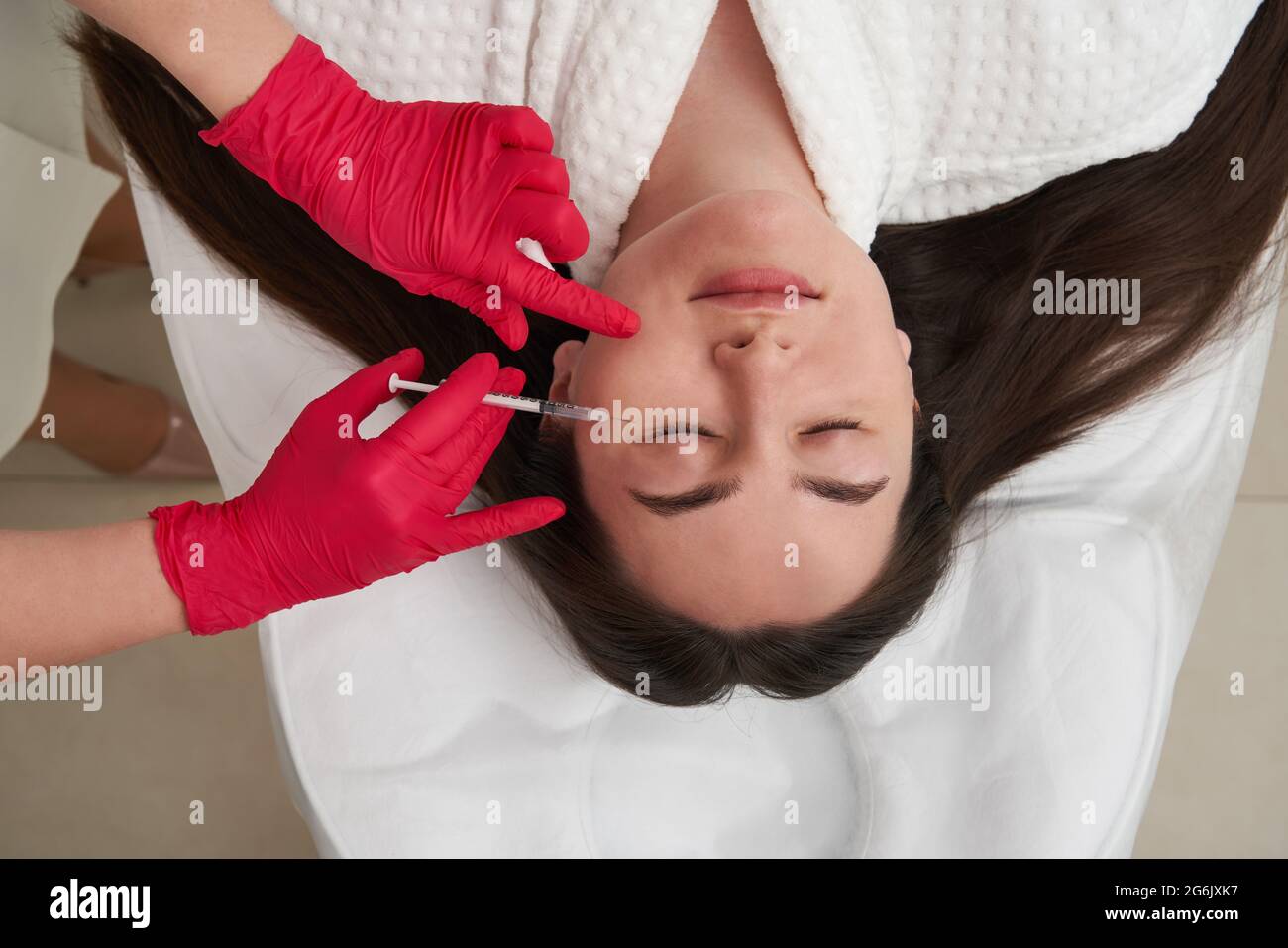Beauty injections into beautiful female face. Smoothing of mimic ...