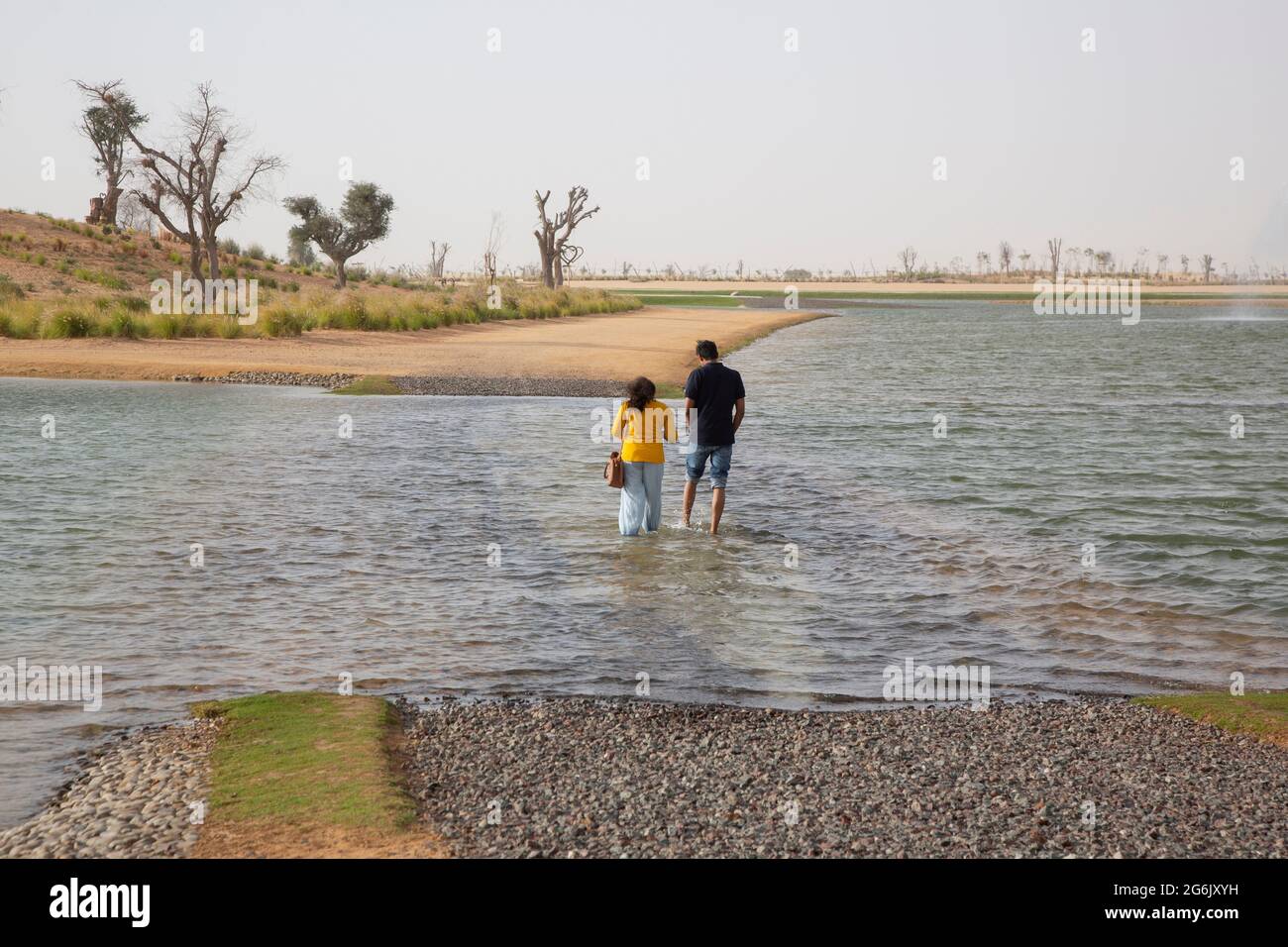 A couple crosses the water at the Love Lakes in Al Qudra, Dubai, UAE ...