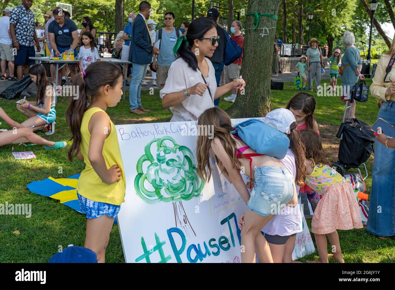 NEW YORK, NY – JULY 05: Children sign a poster calling to save the park ...